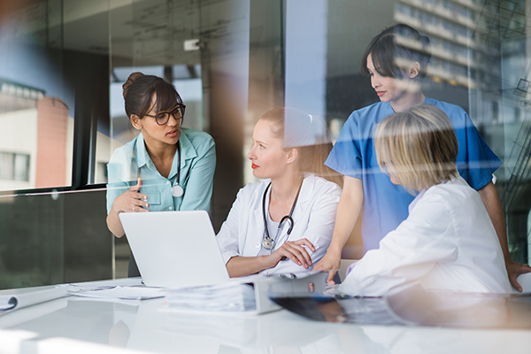 Female doctors discussing at laptop desk | Coffee Regional Medical Center